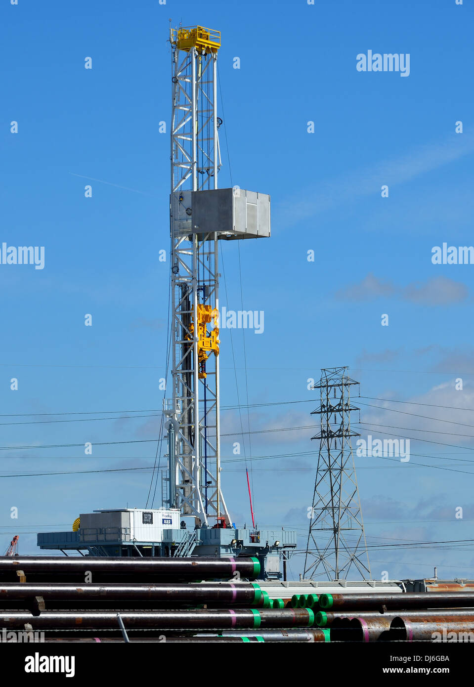 An oil and gas drilling rig, with pile of steel pipes. Texas, USA Stock ...