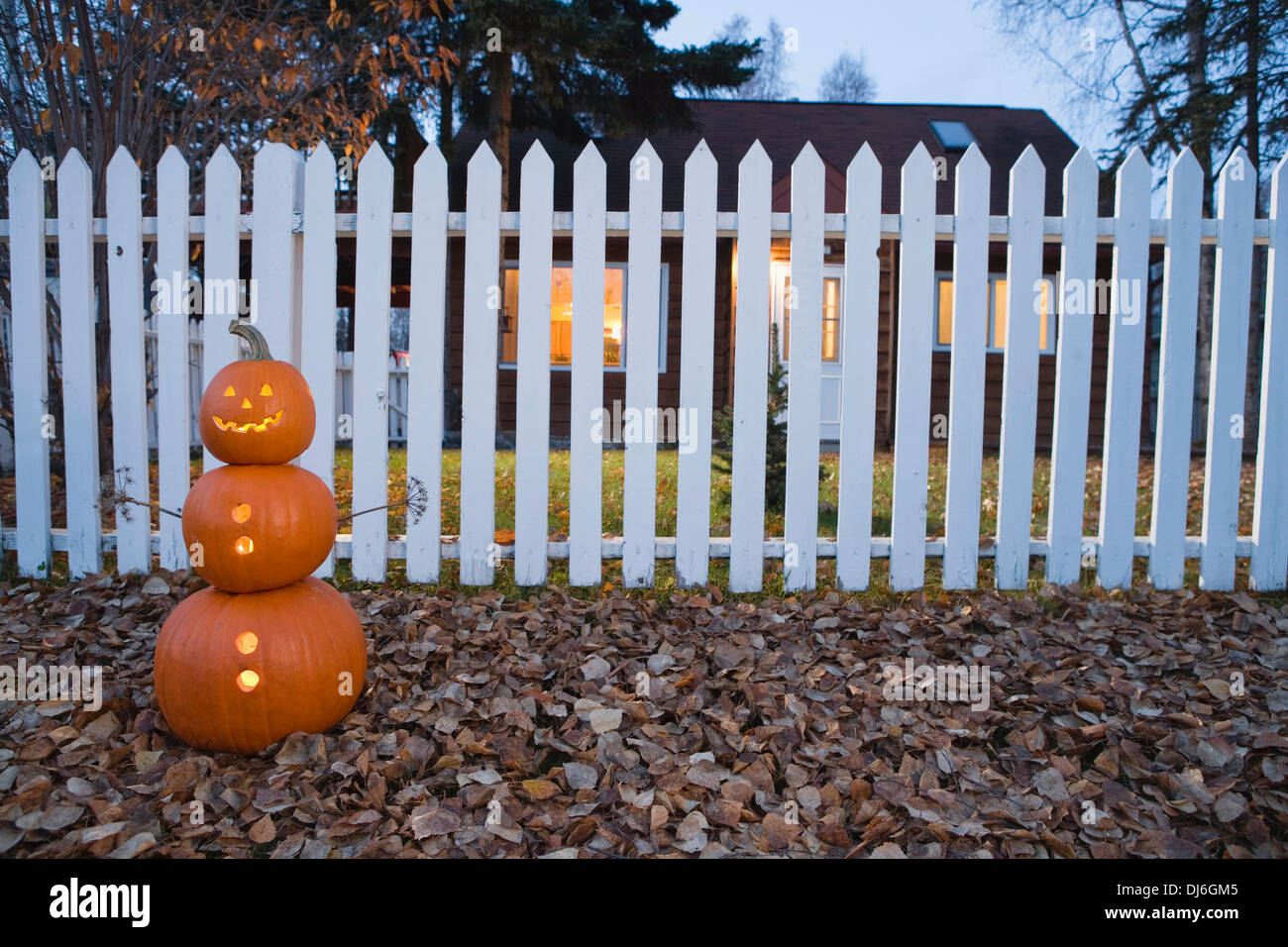 Jack-O-Lantern Man Standing In Front Of A White Picktet Fence With A ...