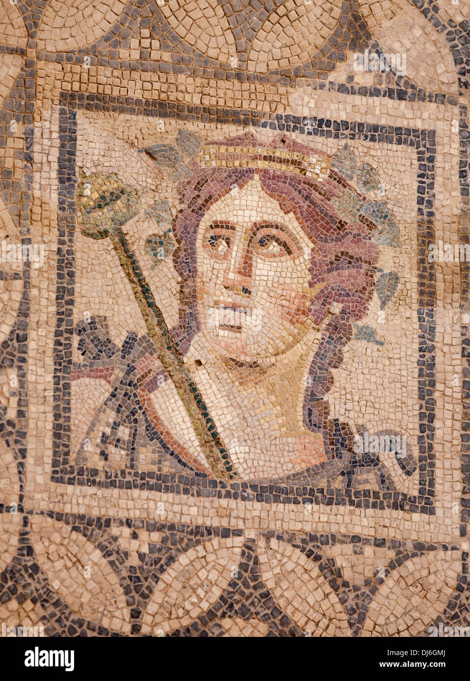 Detail from a ceramic floor mosaic. A portrait of a young man with a ...