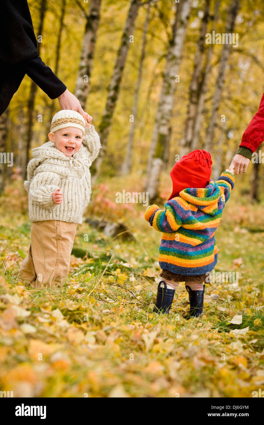 Two Young Girls Playing In The Fall Leaves In An Anchorage Park In ...