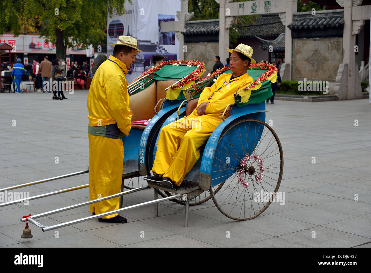 Two men waiting by their rickshaws at the historic Confucius Temple ...