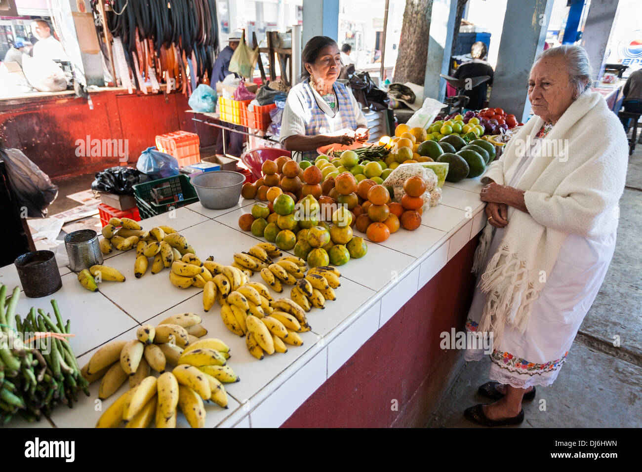 Waiting for Service at the market. An old woman waits for her fruit to ...