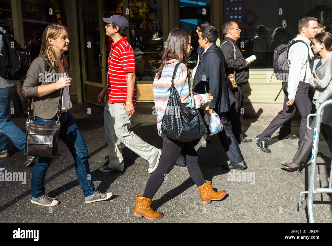 Pedestrians walk on a sidewalk outside of Grand Central Station, New ...