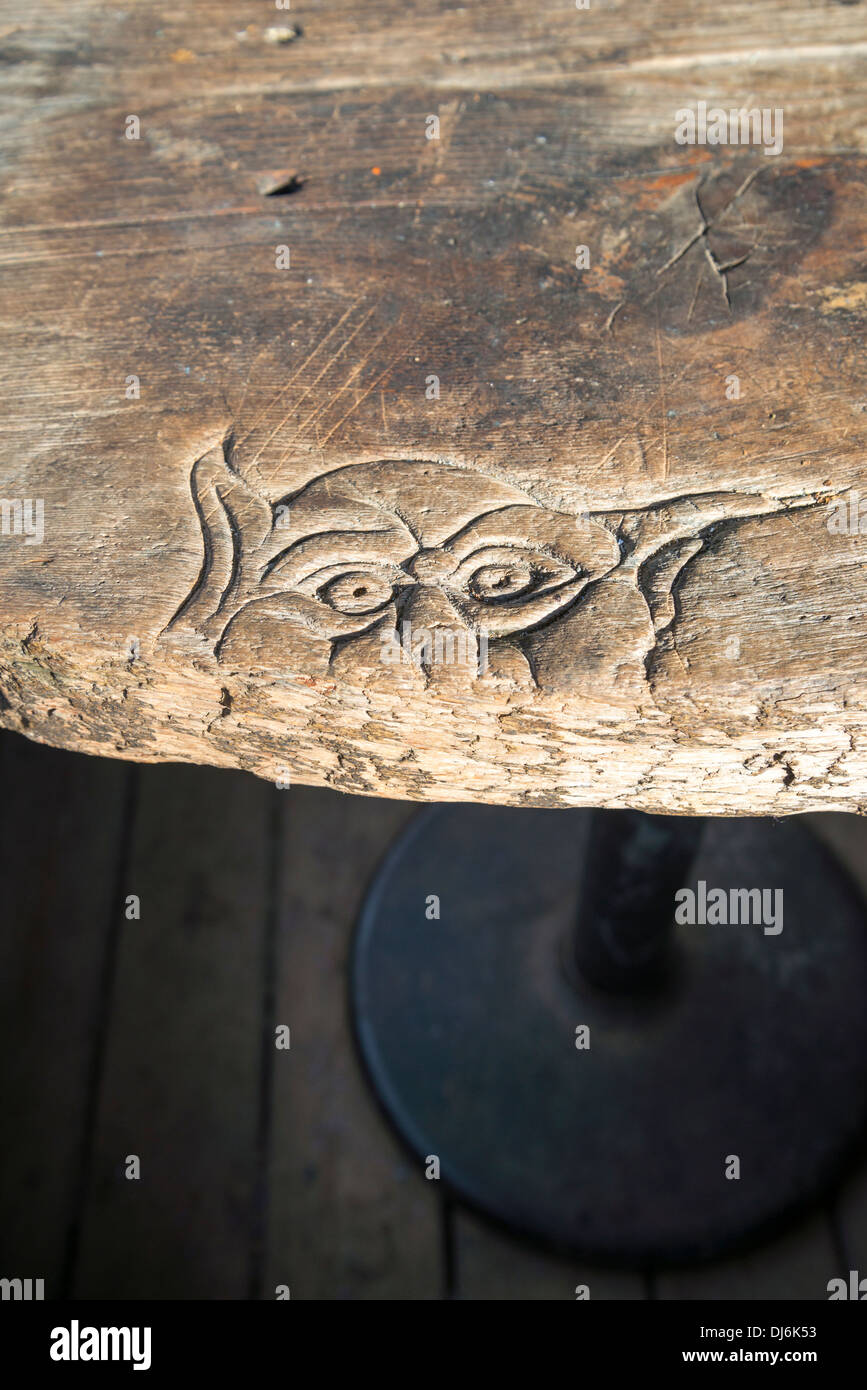 Rustic carved tabletop face table hi-res stock photography and images ...