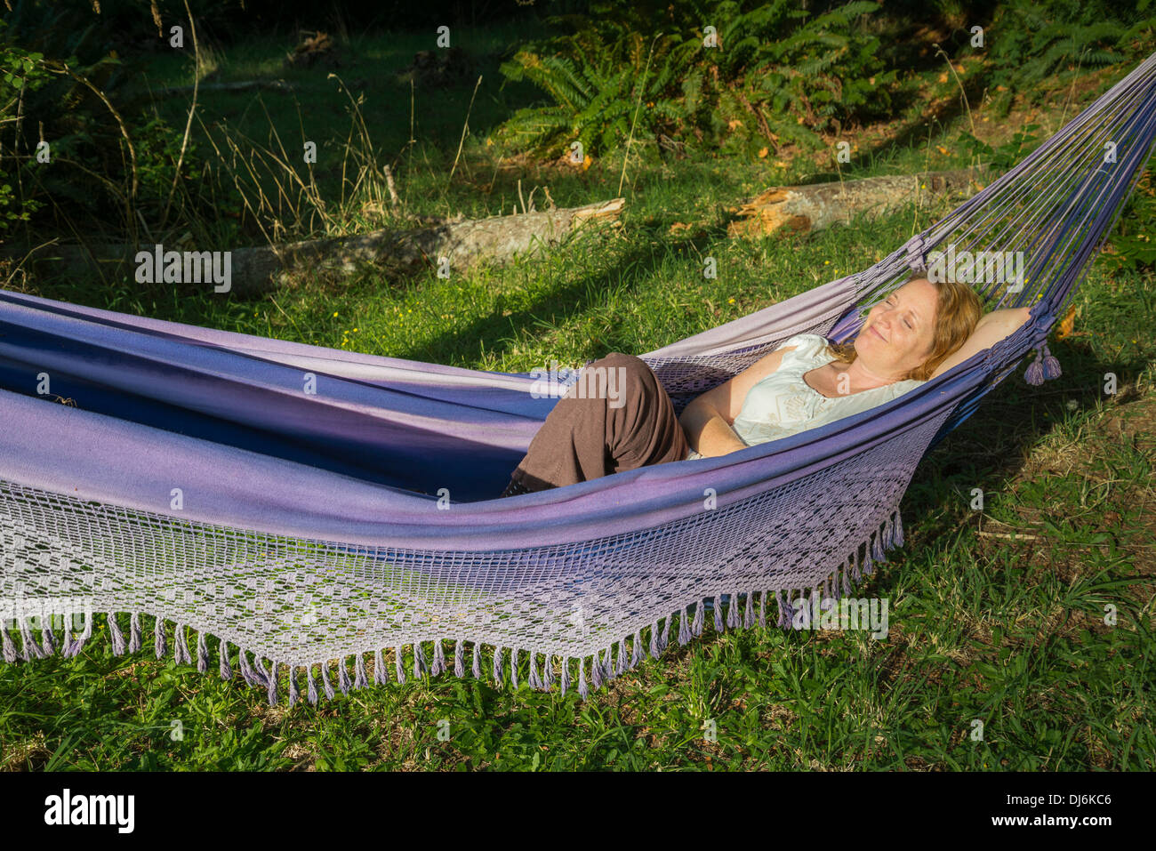Woman enjoying rest in hammock Stock Photo - Alamy