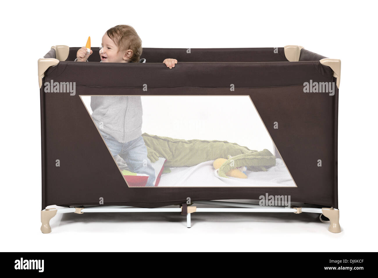 Child playing in portable play bed Stock Photo - Alamy