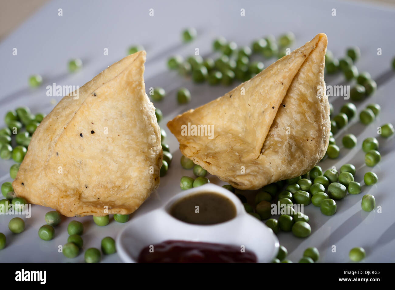 Fresh hot Vegetable Samosas with chutney Stock Photo - Alamy