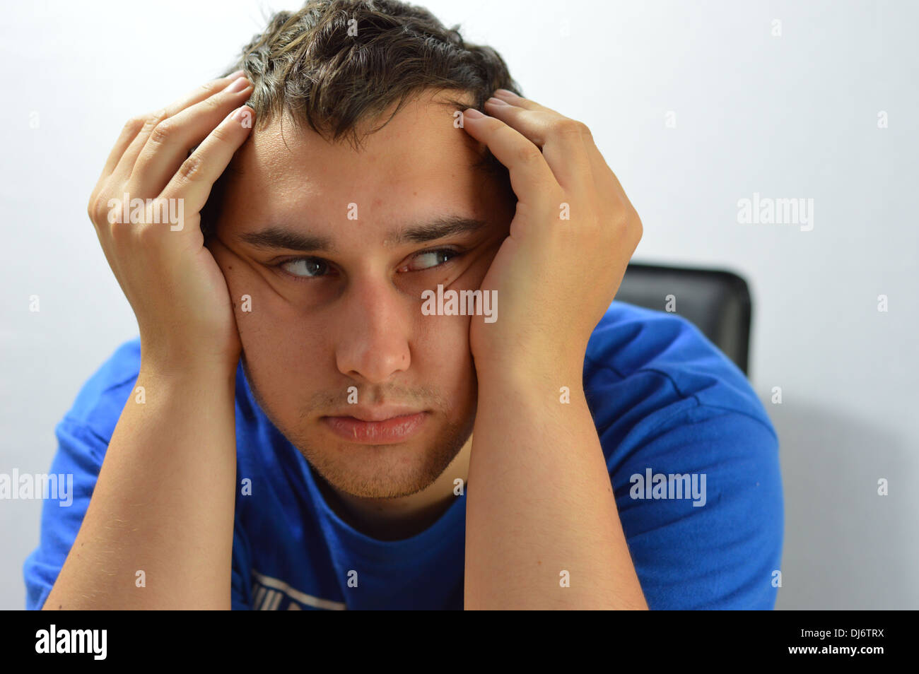 feeling fed up and grumpy, a close up of a young mans face, does he ...