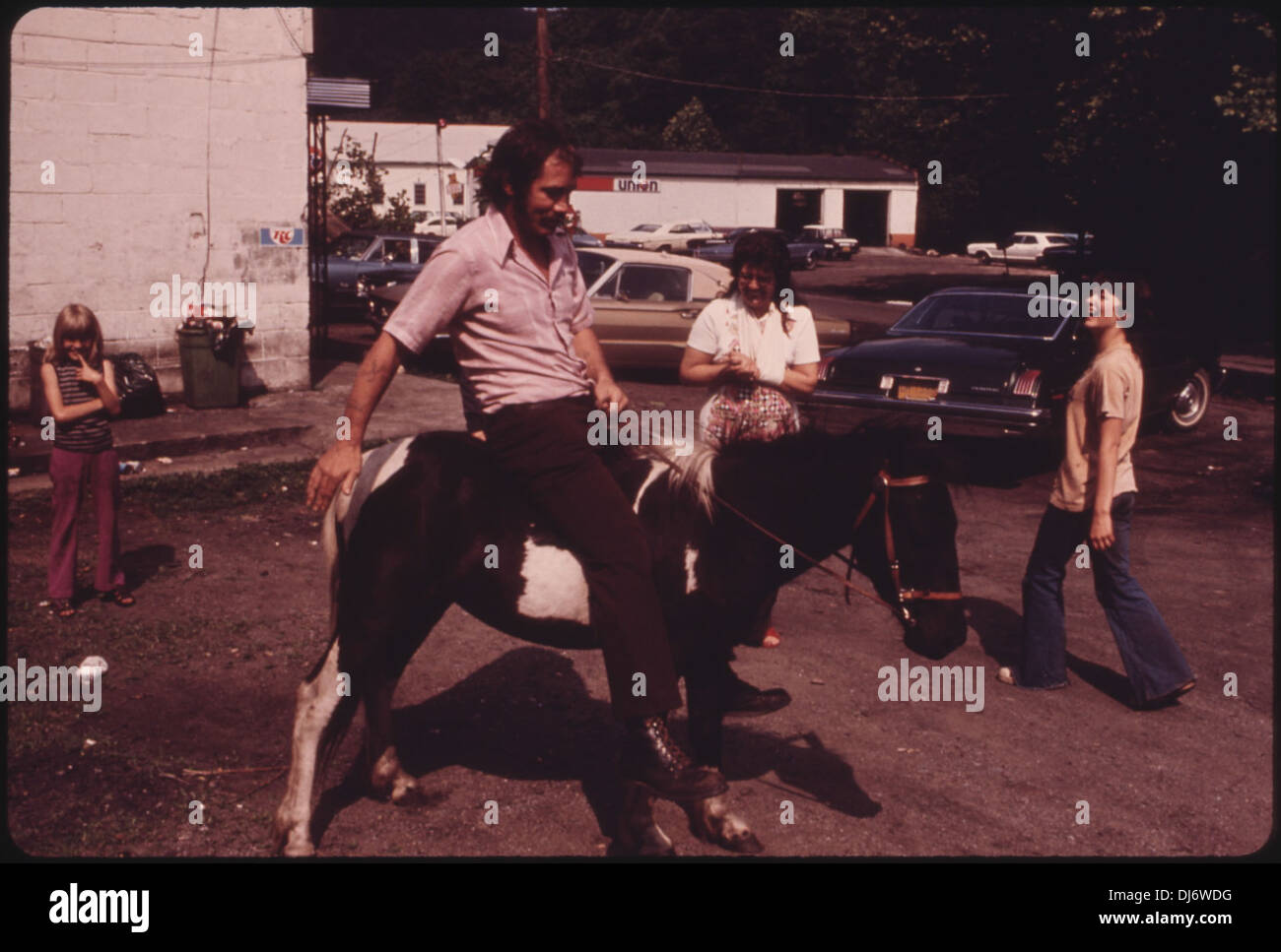 A MINER WHO HAD COMPLETED HIS WORK SHIFT IS SHOWN ON A PONY BELONGING ...