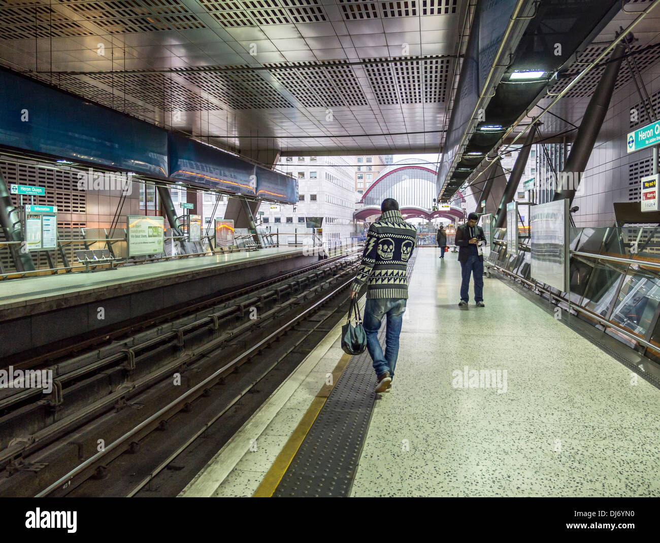 Passengers waiting on platform of DLR (Dockland Light Railway) modern ...