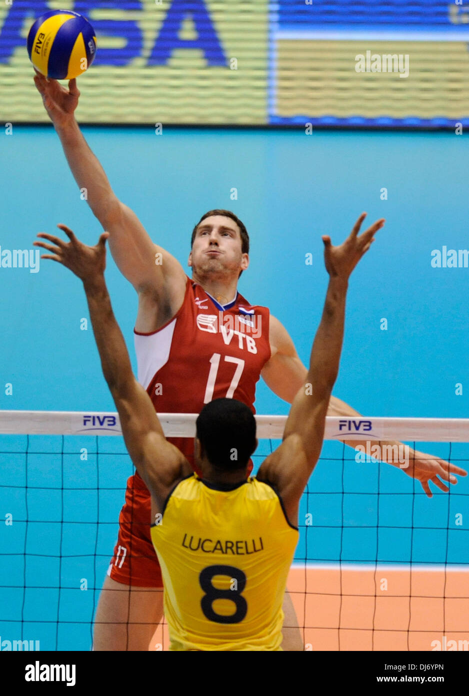 Tokyo, Japan. 23rd Nov, 2013. Maxim Mikhaylov (Rear) of Russia spikes ...