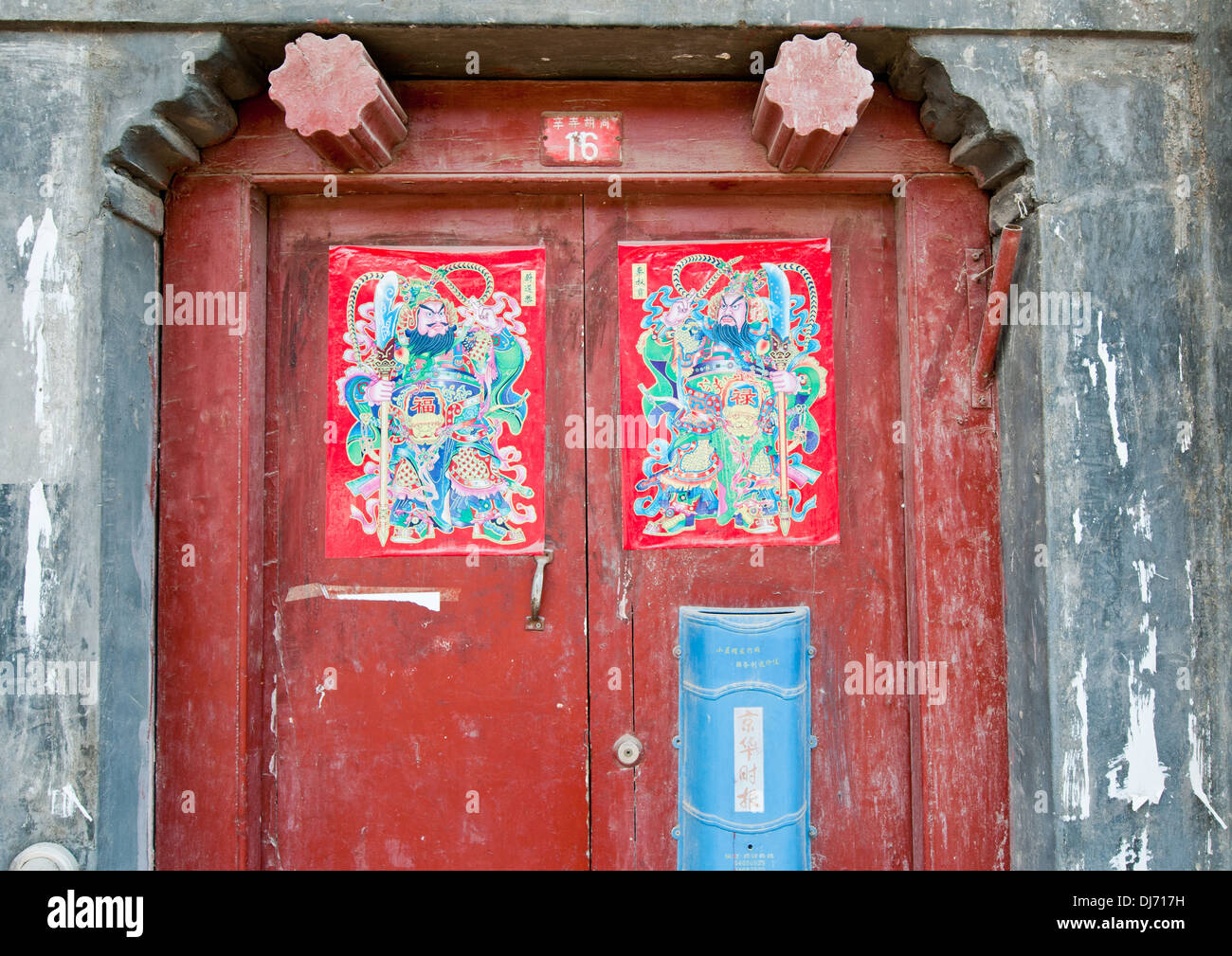 Red door with guardian poster in hutong area, Beijing, China Stock ...