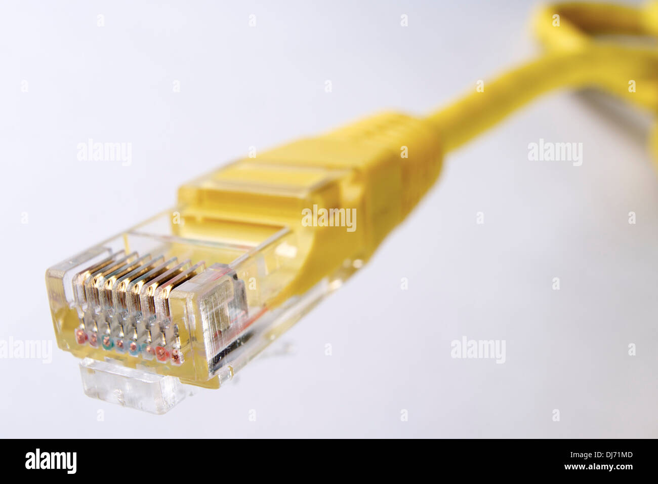 Yellow ethernet cable computer and white background Stock Photo - Alamy
