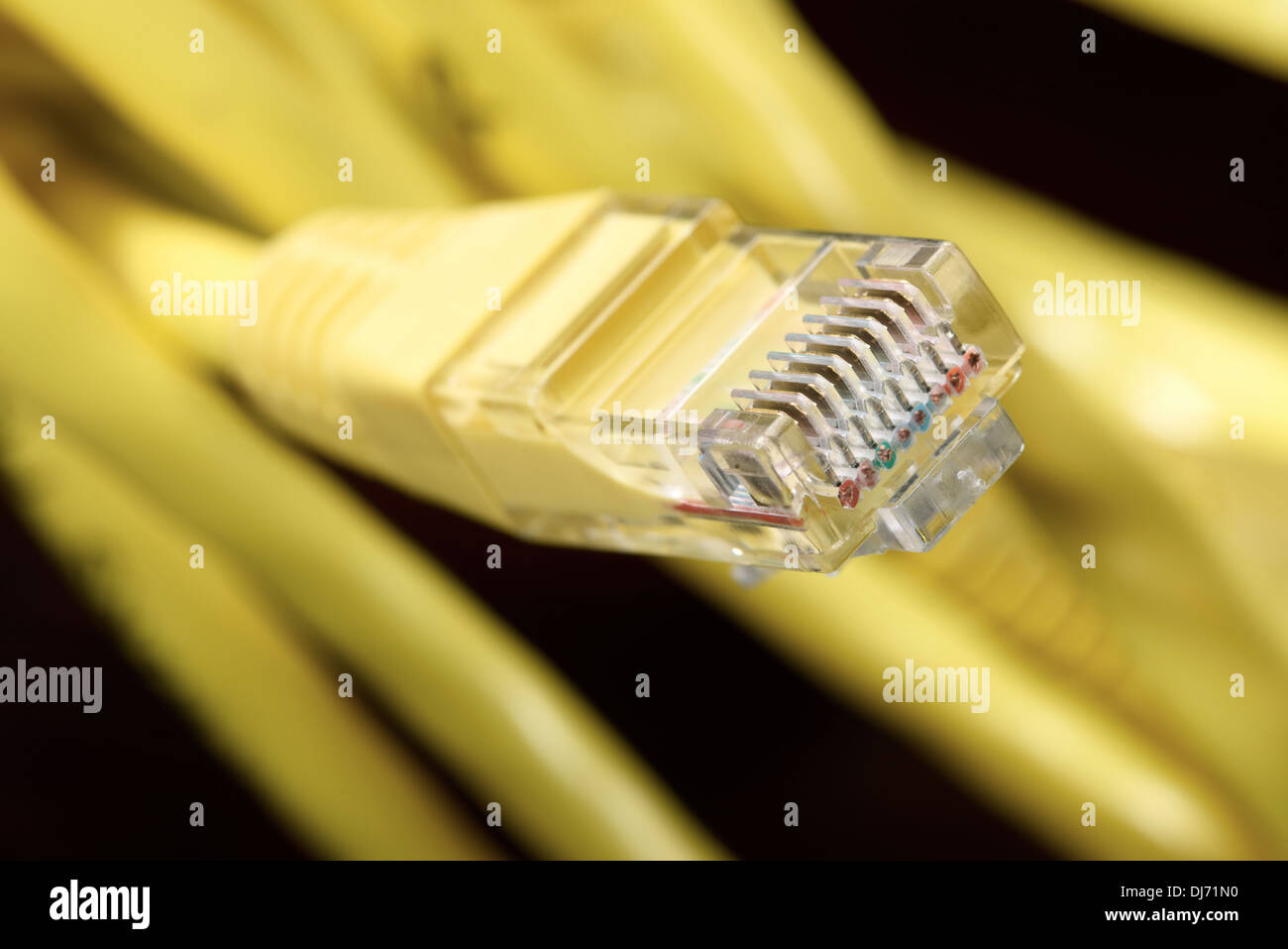 Yellow ethernet cable computer and black background Stock Photo - Alamy