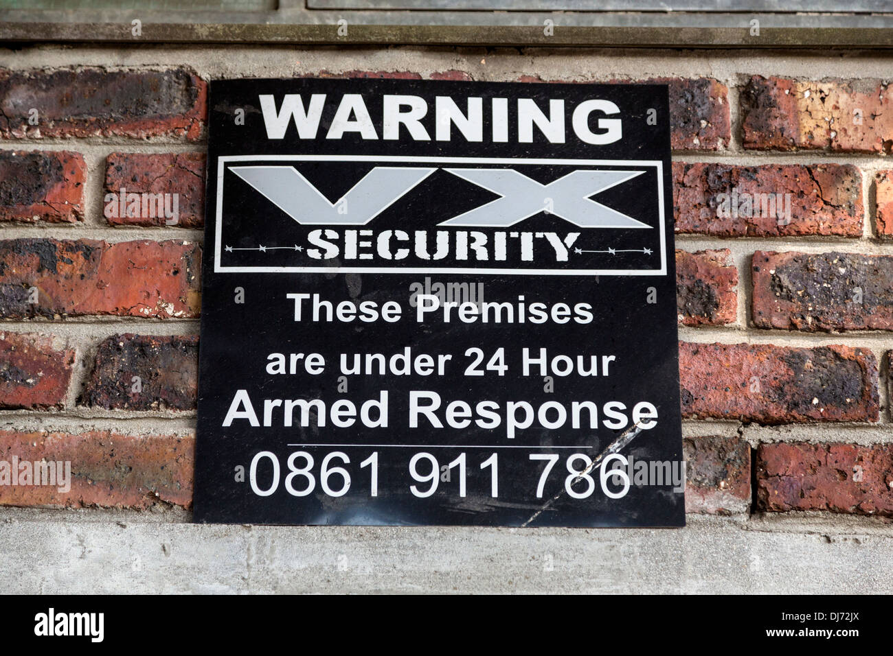 South Africa, Cape Town. Sign Warning Intruders that Facility is under ...