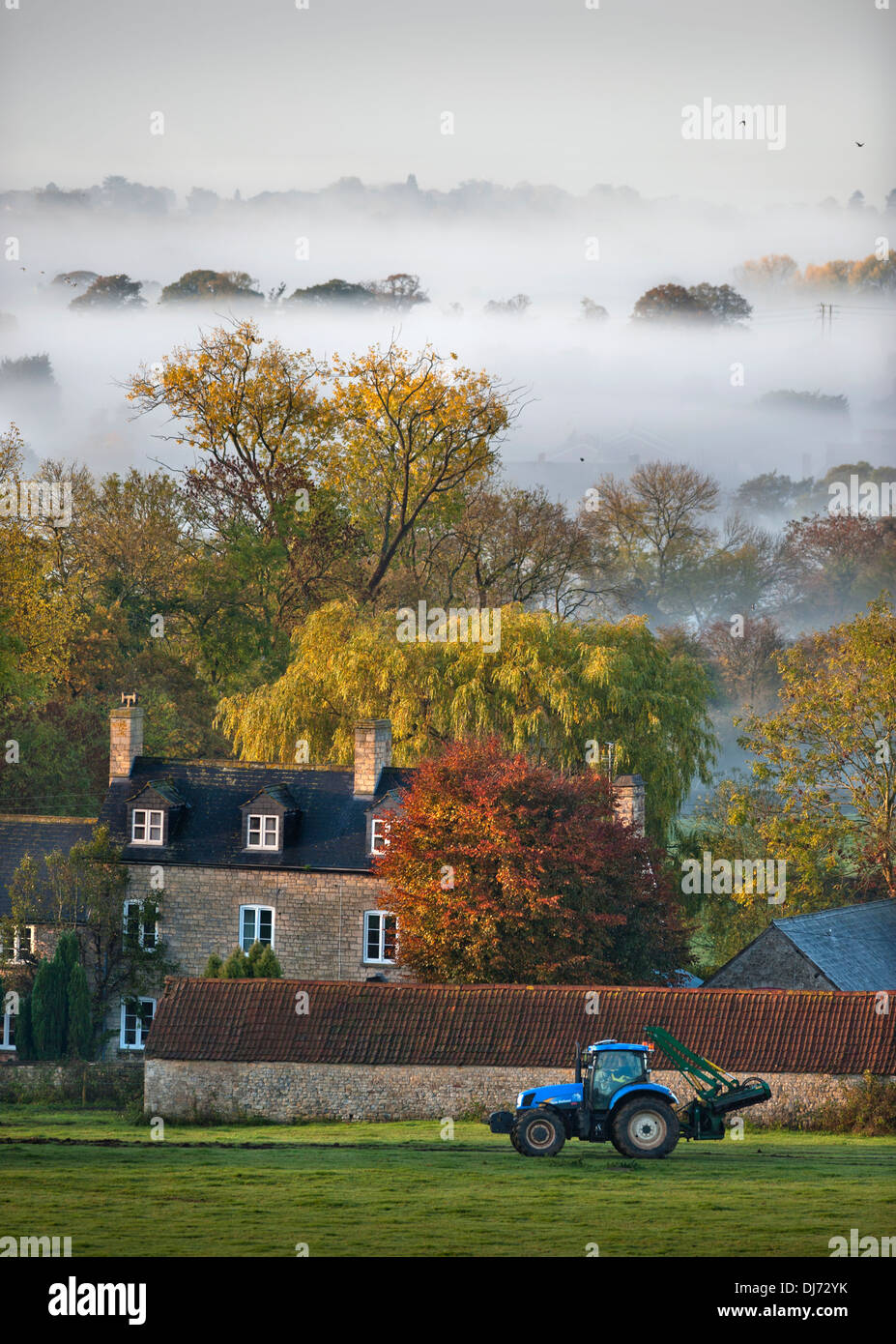 A farmhouse surrounded by Autumn clour on a misty morning near Wotton ...