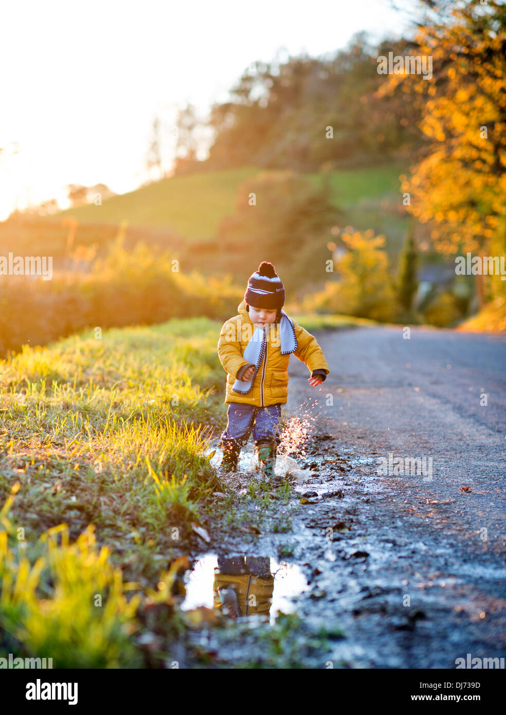 Kid splashing small puddle hi-res stock photography and images - Alamy