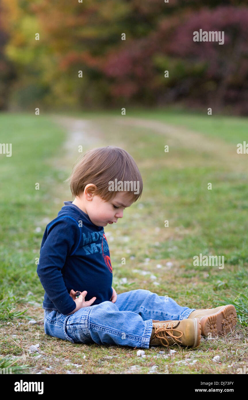 Toddler Sitting on Autumn Path in Southern Indiana Stock Photo - Alamy