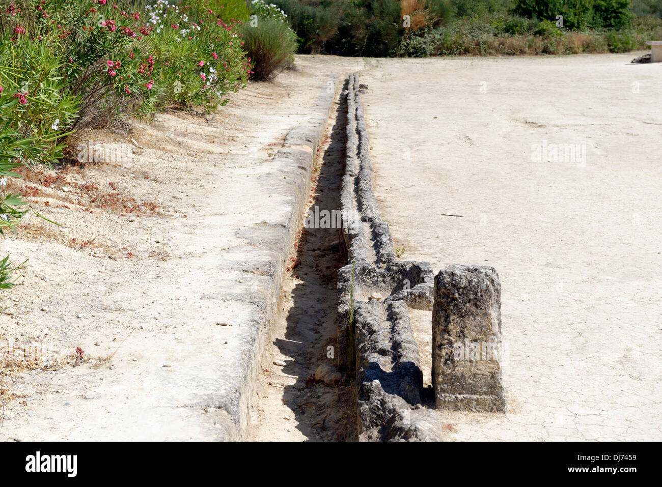 Fresh water stone channel along the side of the stadium running track ...