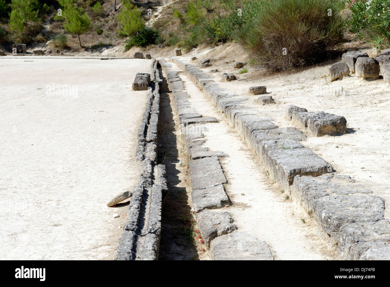 Fresh water stone channel along the side of the stadium running track ...