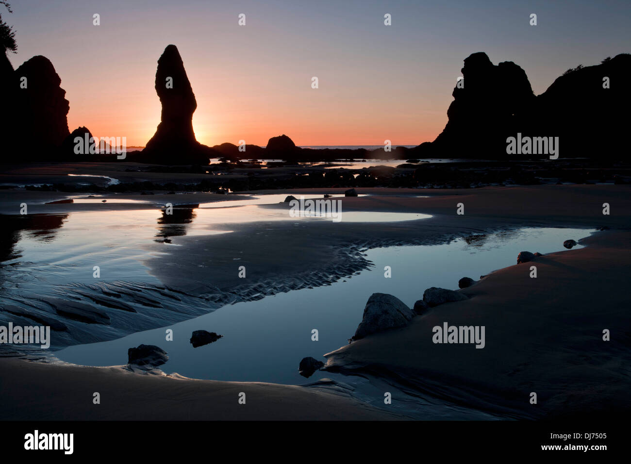 The sun sets behind a sea stack at Point of the Arches along Shi Shi ...