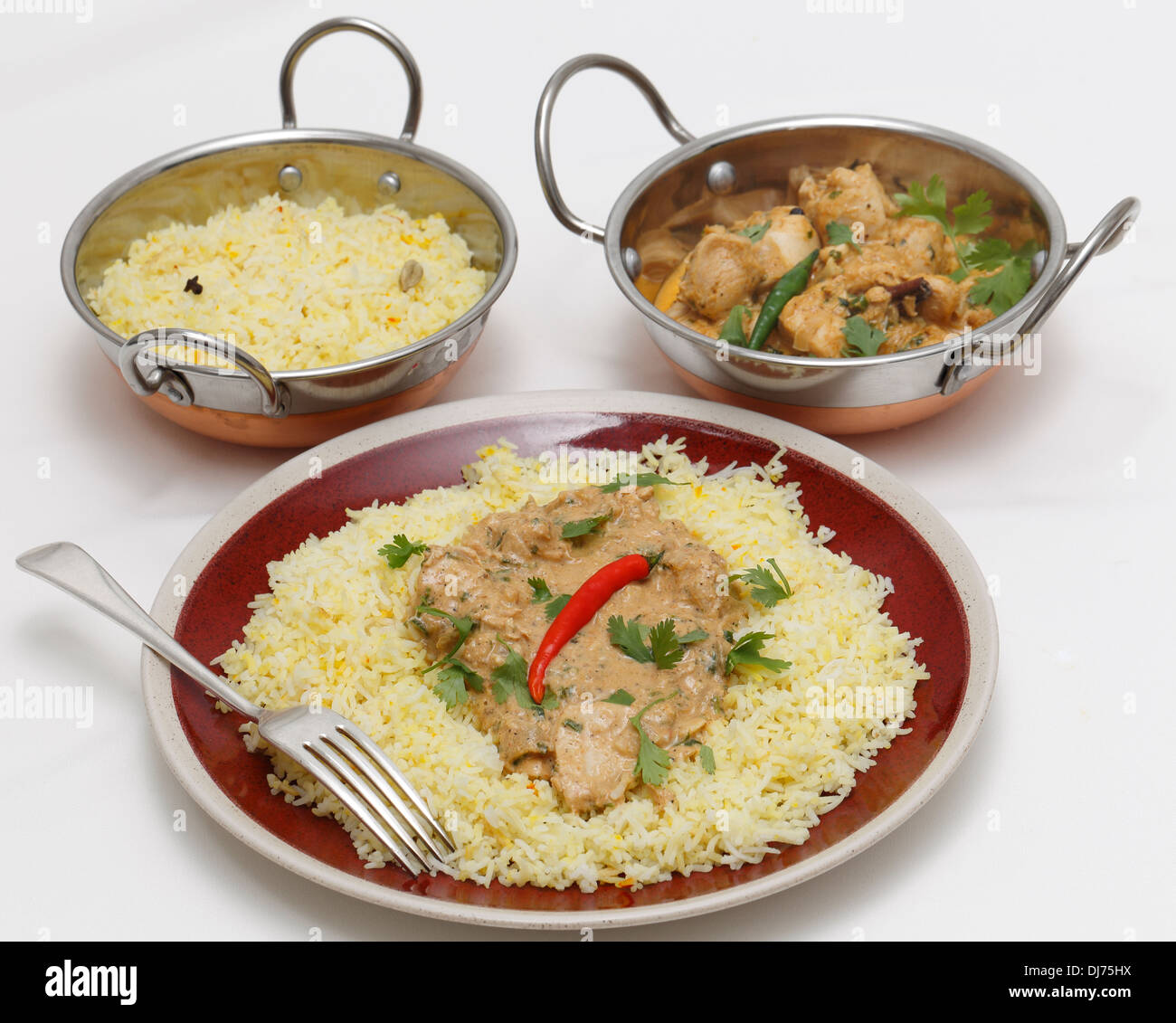 balti chicken pasanda curry served on a bed of saffron rice, garnished ...