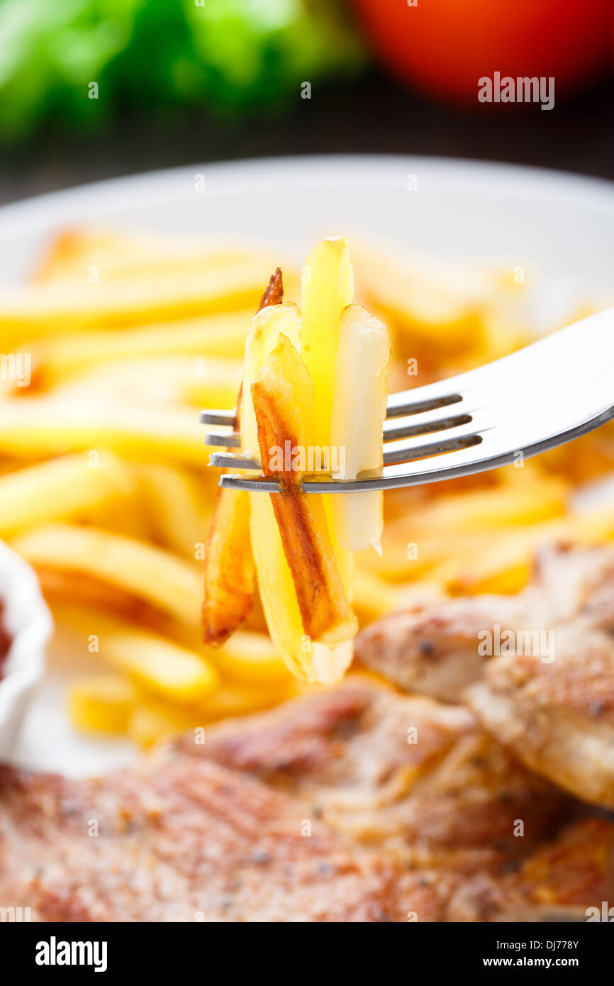 French fries on a fork Stock Photo - Alamy
