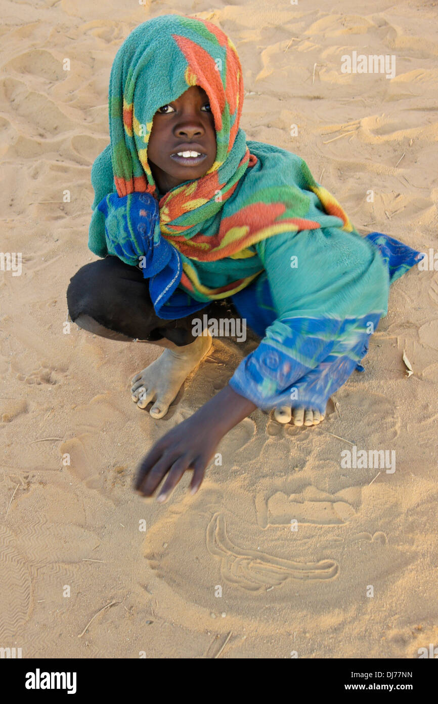 Malagasy boy drawing picture in dirt, Morondava, Madagasar Stock Photo ...