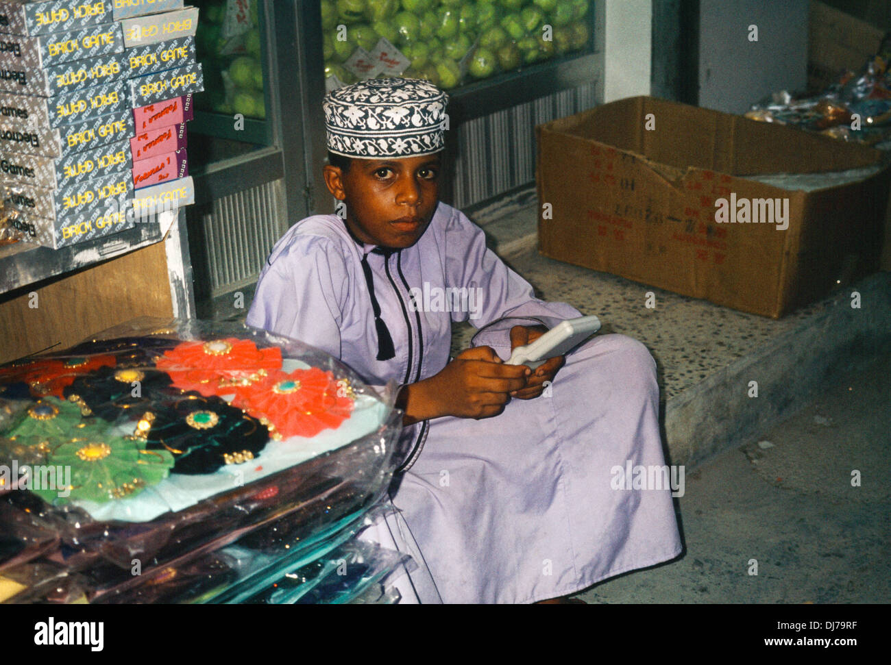 Dubai UAE Young Boy Sitting On Ground At Souk Stock Photo - Alamy
