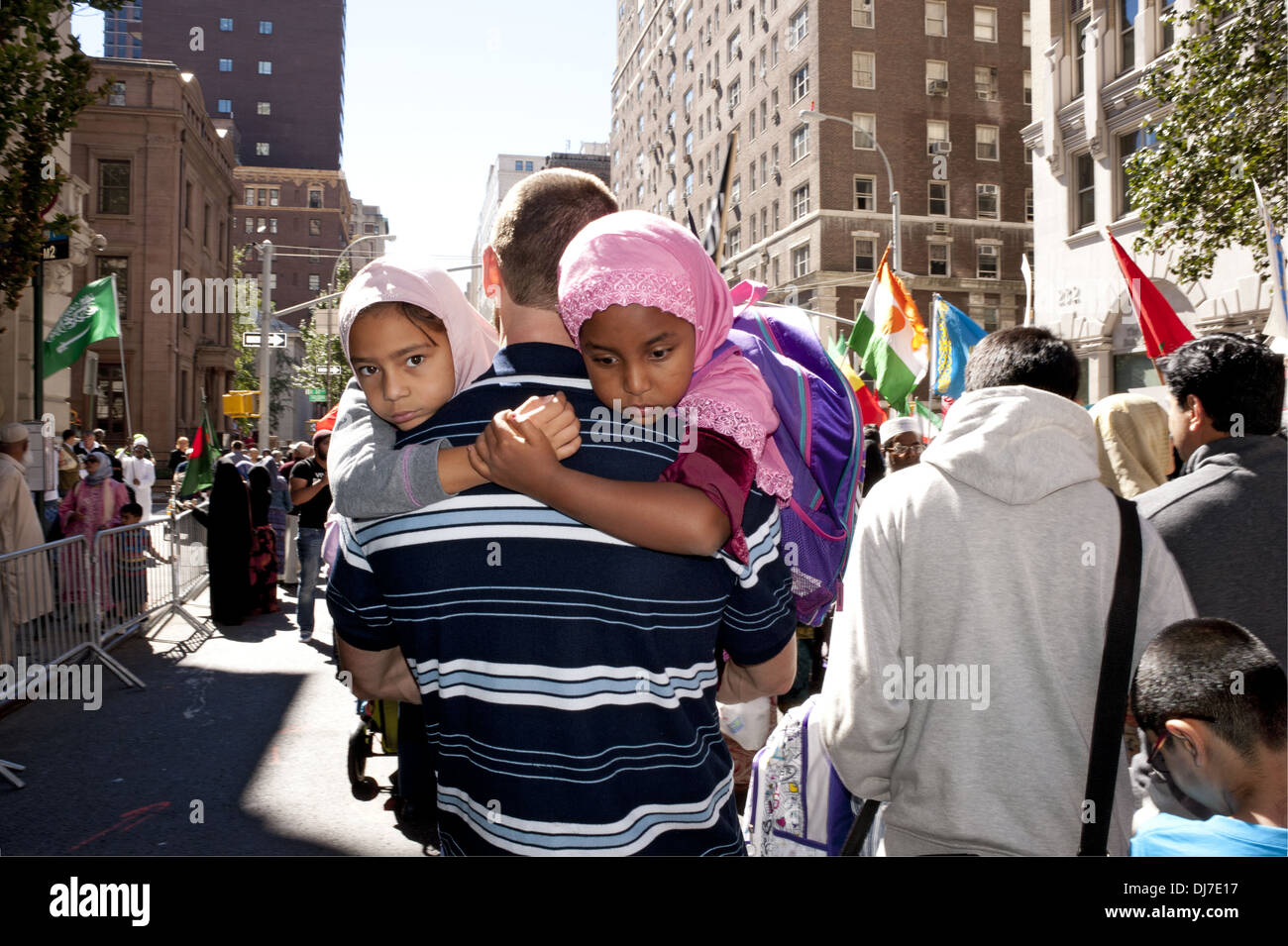 Annual Muslim Day Parade, New York City, 2012. Father carries his ...