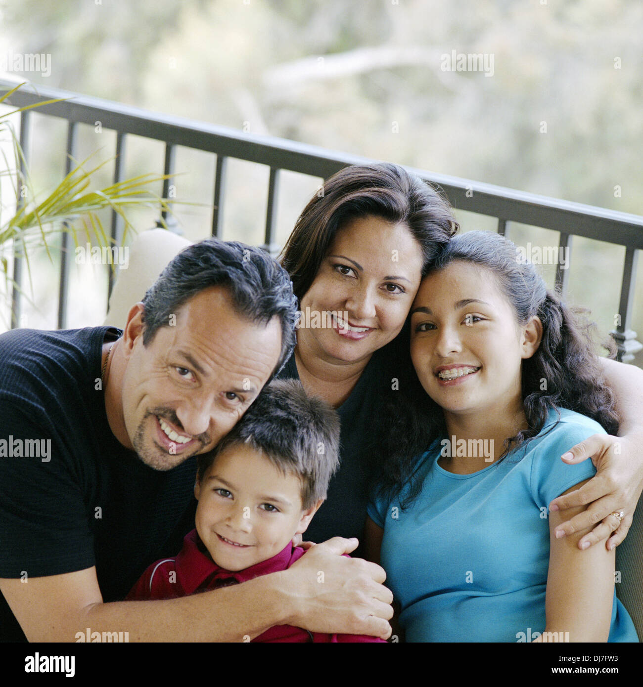 Hispanic Family Smiling Posing on Balcony Stock Photo - Alamy