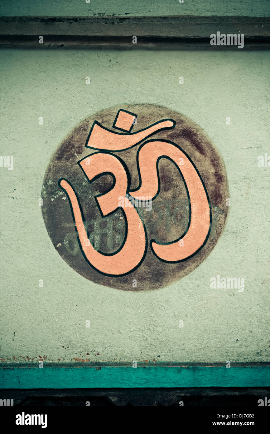 A holy sign called om is painted on front side of a Hindu temple ...