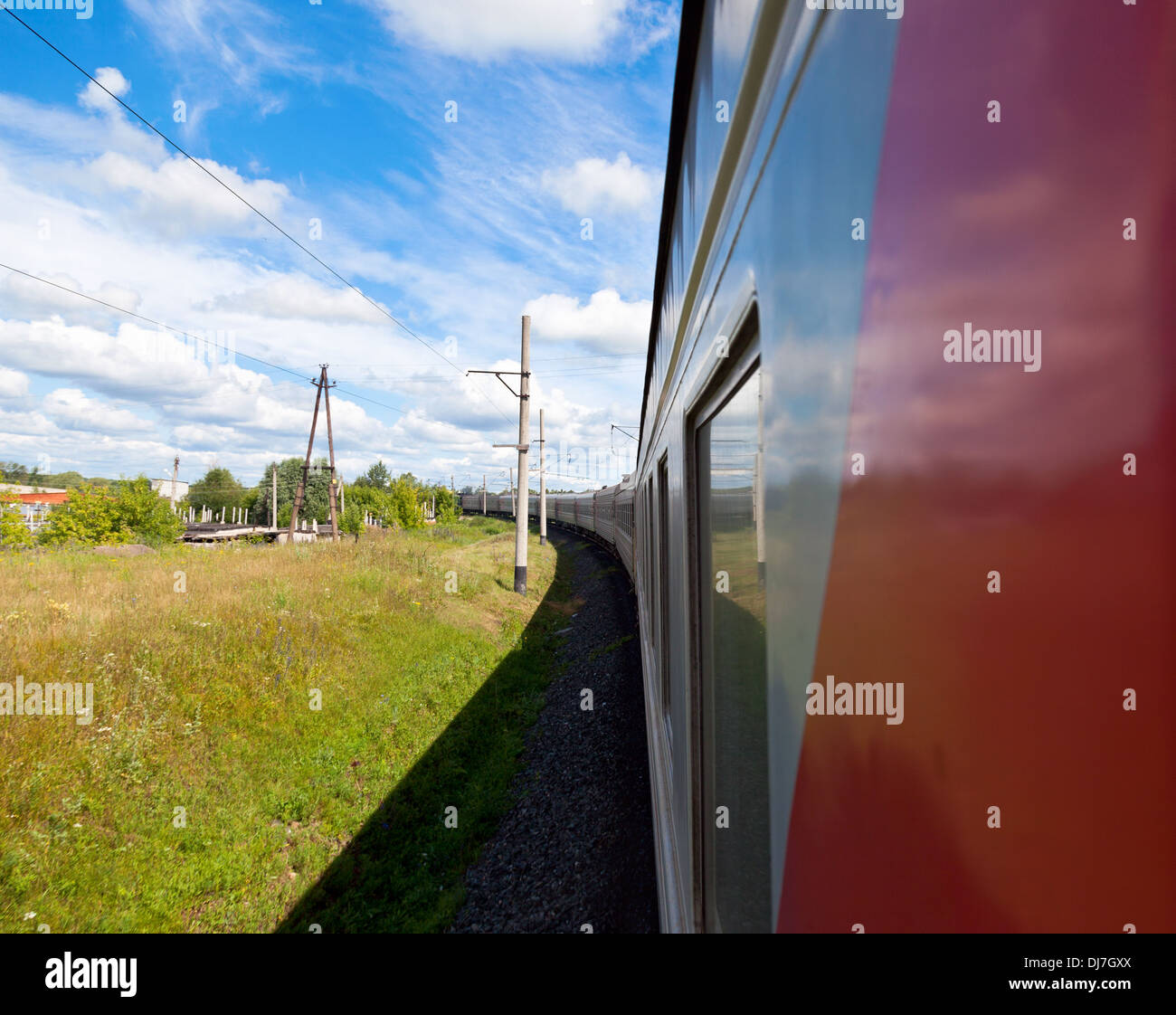 Train goes by rail in summer day, countryside Stock Photo - Alamy
