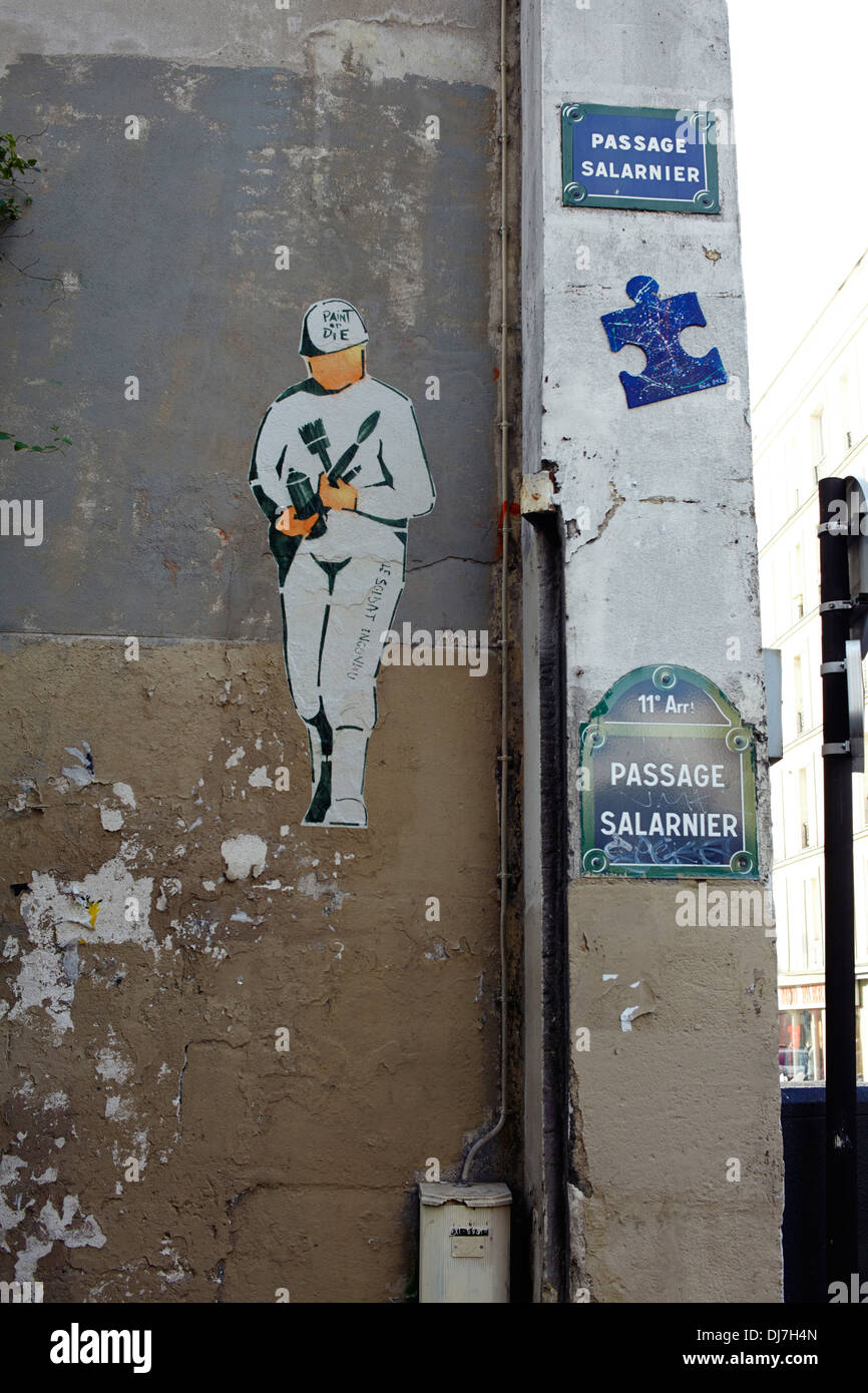 Paint or die figure on wall in Paris Stock Photo - Alamy