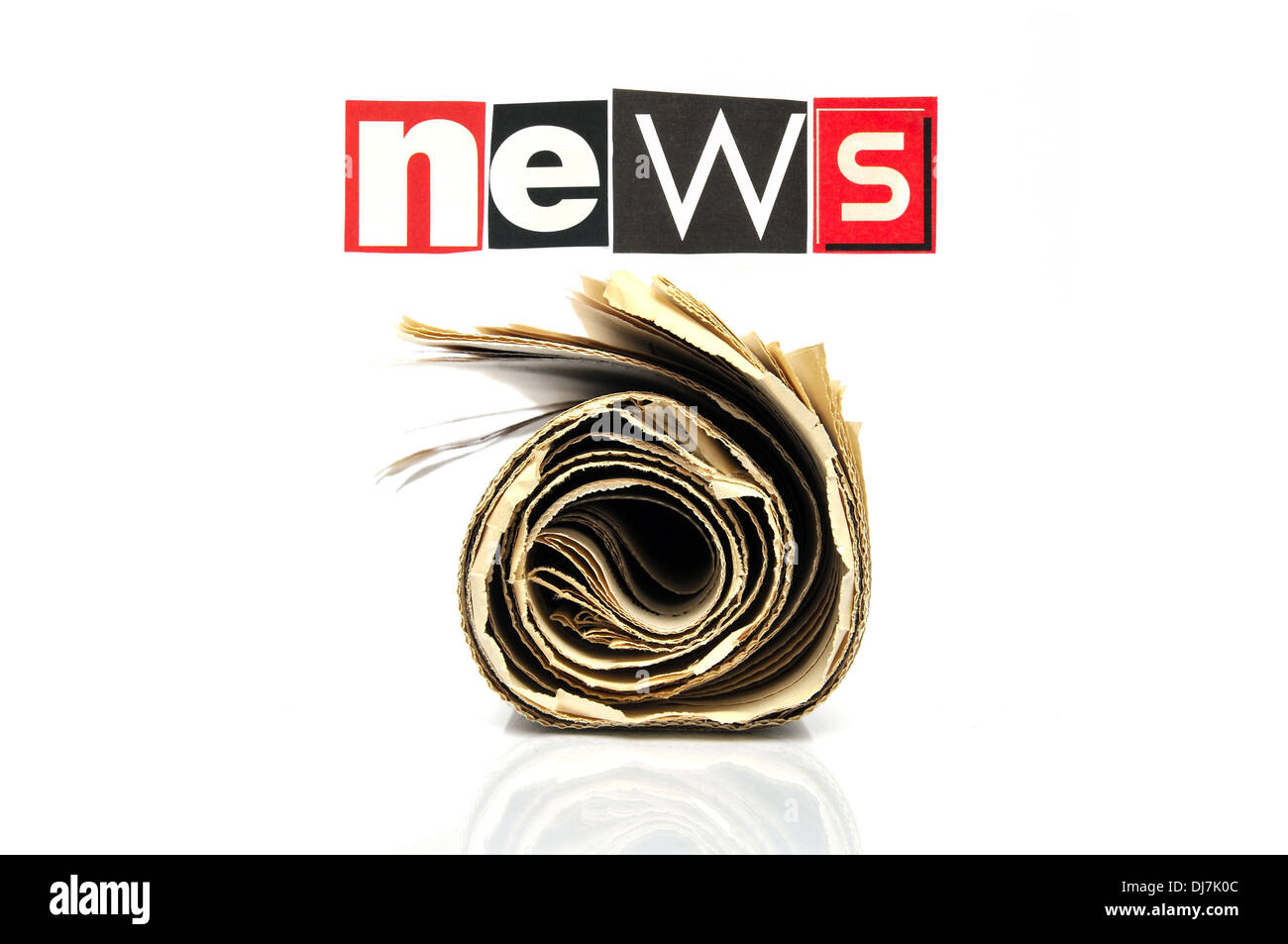 Rolled newspaper below the lettering news Stock Photo - Alamy