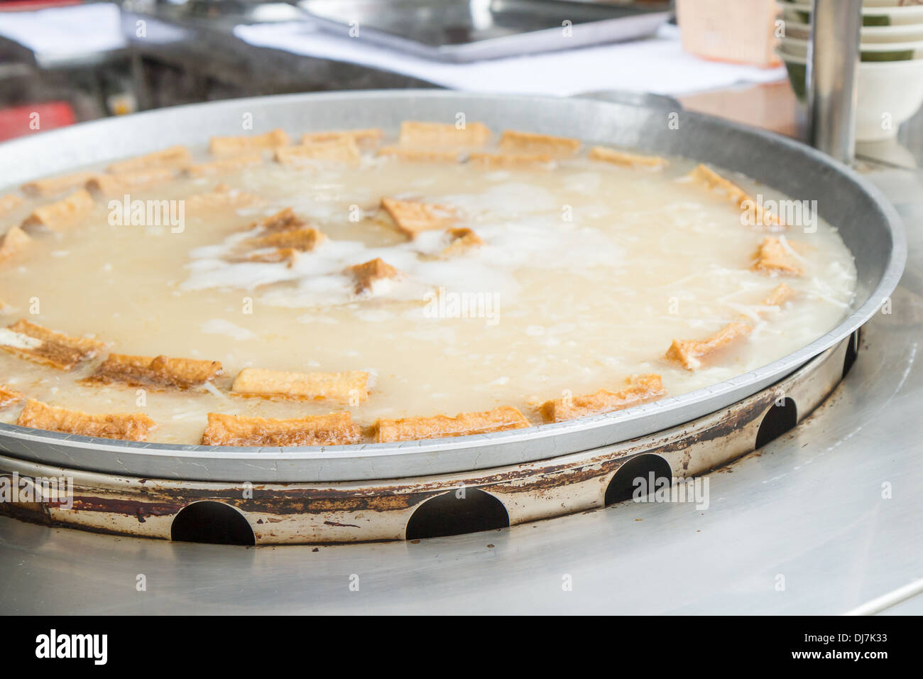 Big dish of tofu being boiled at a stall Stock Photo - Alamy