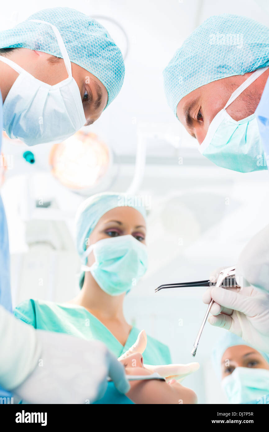 Hospital - surgery team in operating room or Op of a clinic operating ...