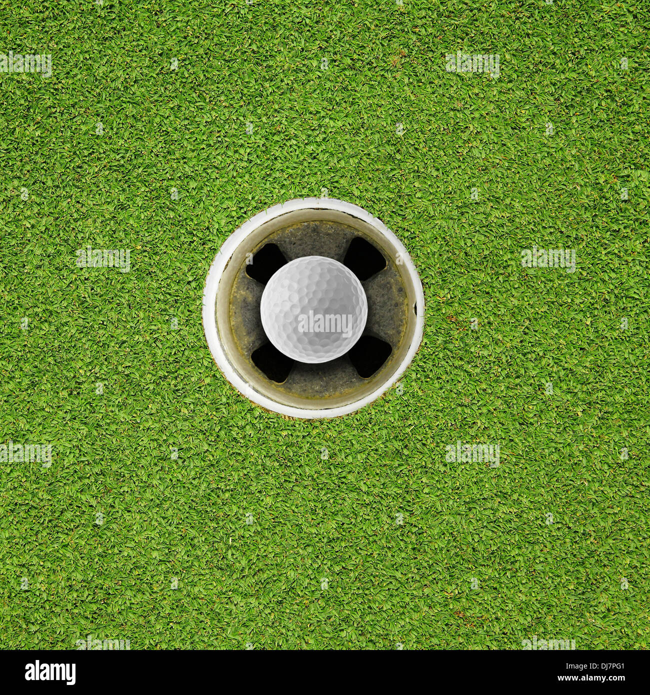 Golf ball in hole Stock Photo - Alamy
