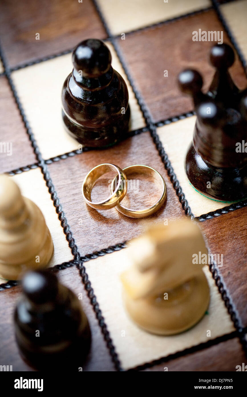 Wedding rings on the chess checkered Stock Photo - Alamy