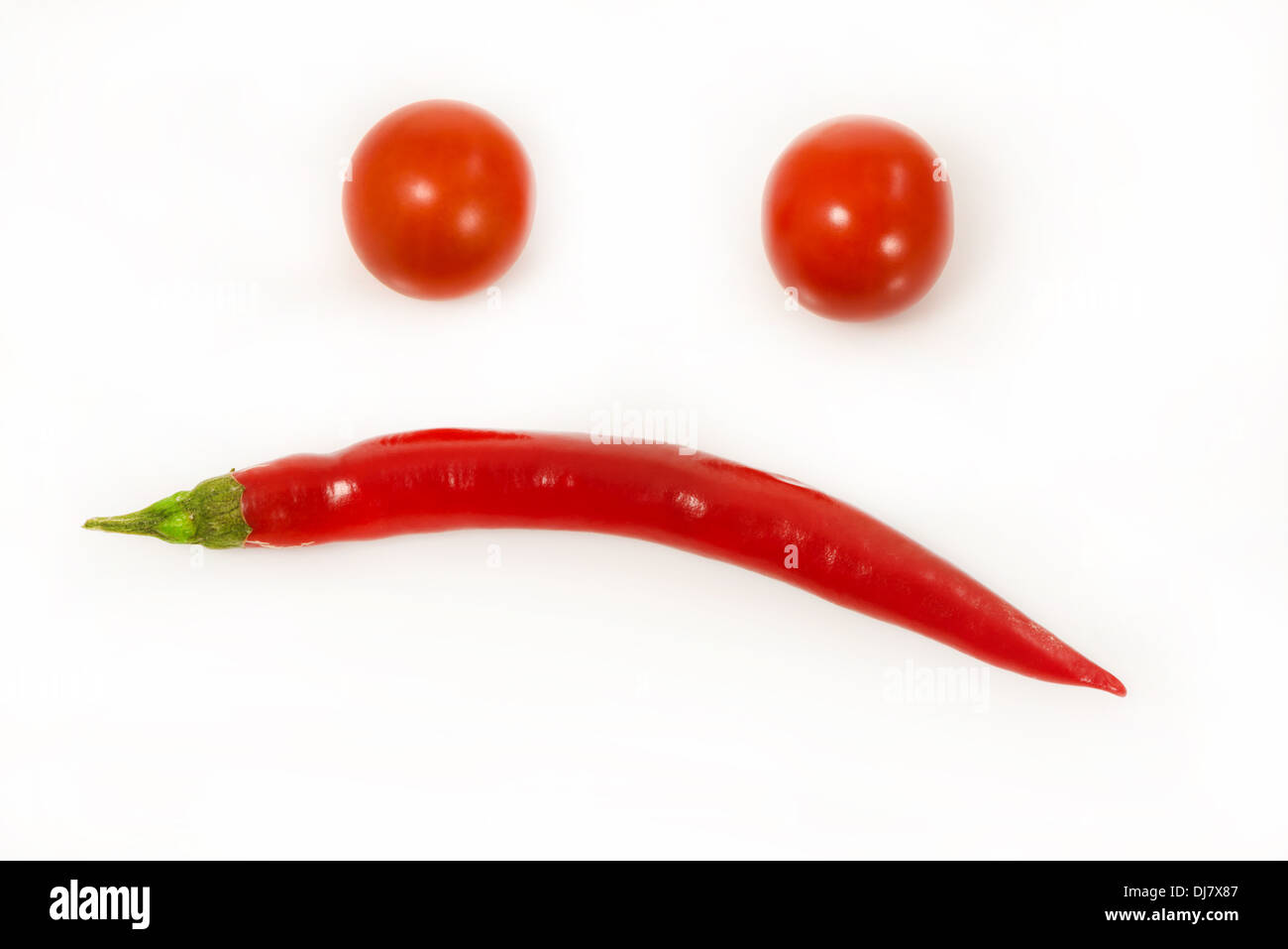 frowning smile, a joke - hot red chili pepper and tomatoes Stock Photo ...