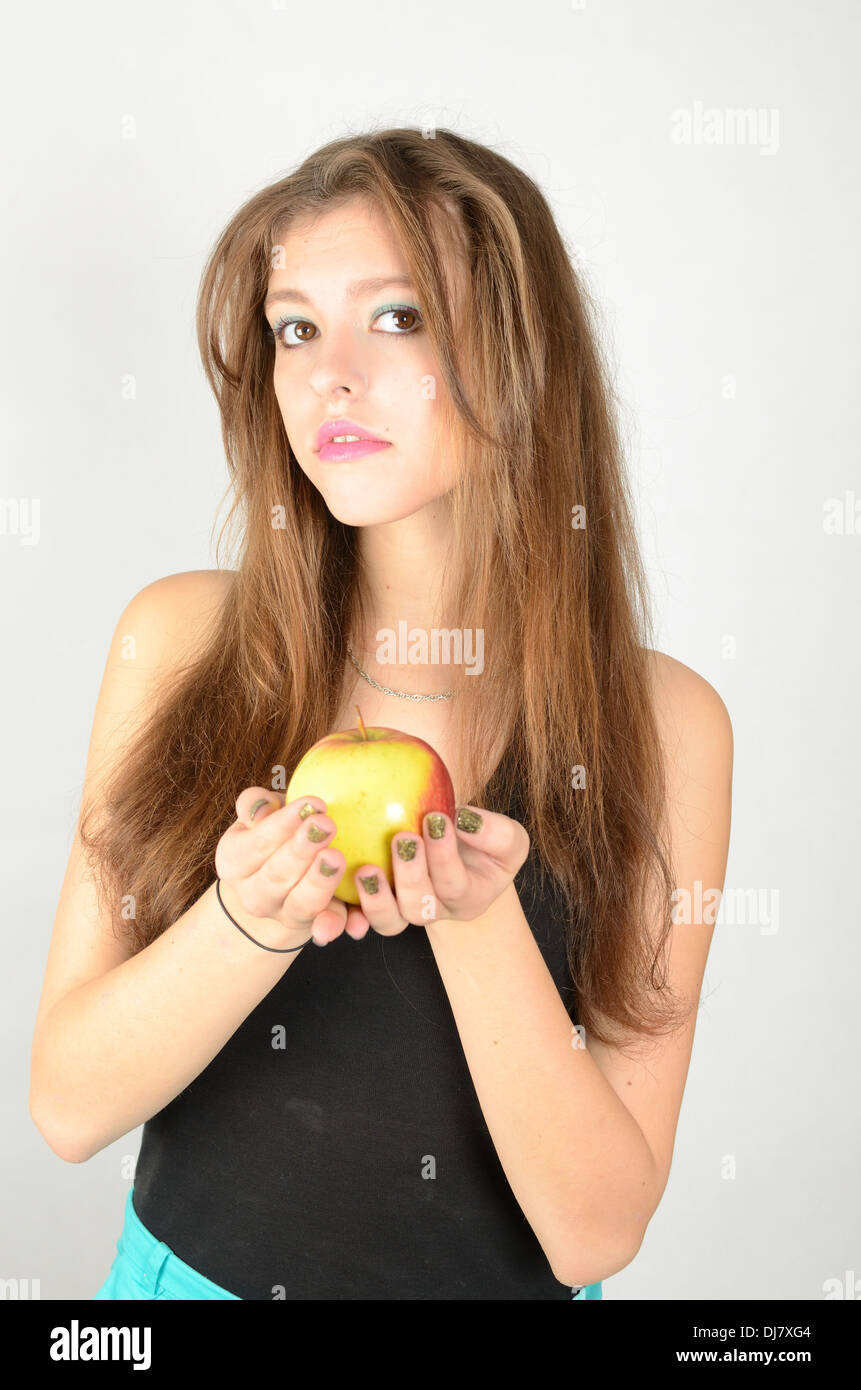 Pretty, young girl holding apple. Female model showing healthy ...