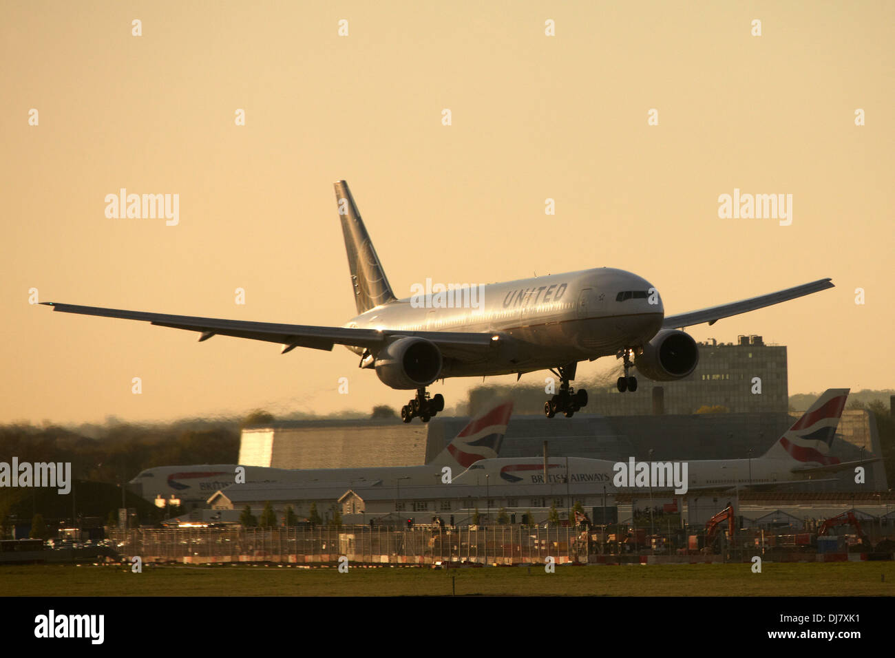 United Boeing 777 landing at London Heathrow airport during sunset ...
