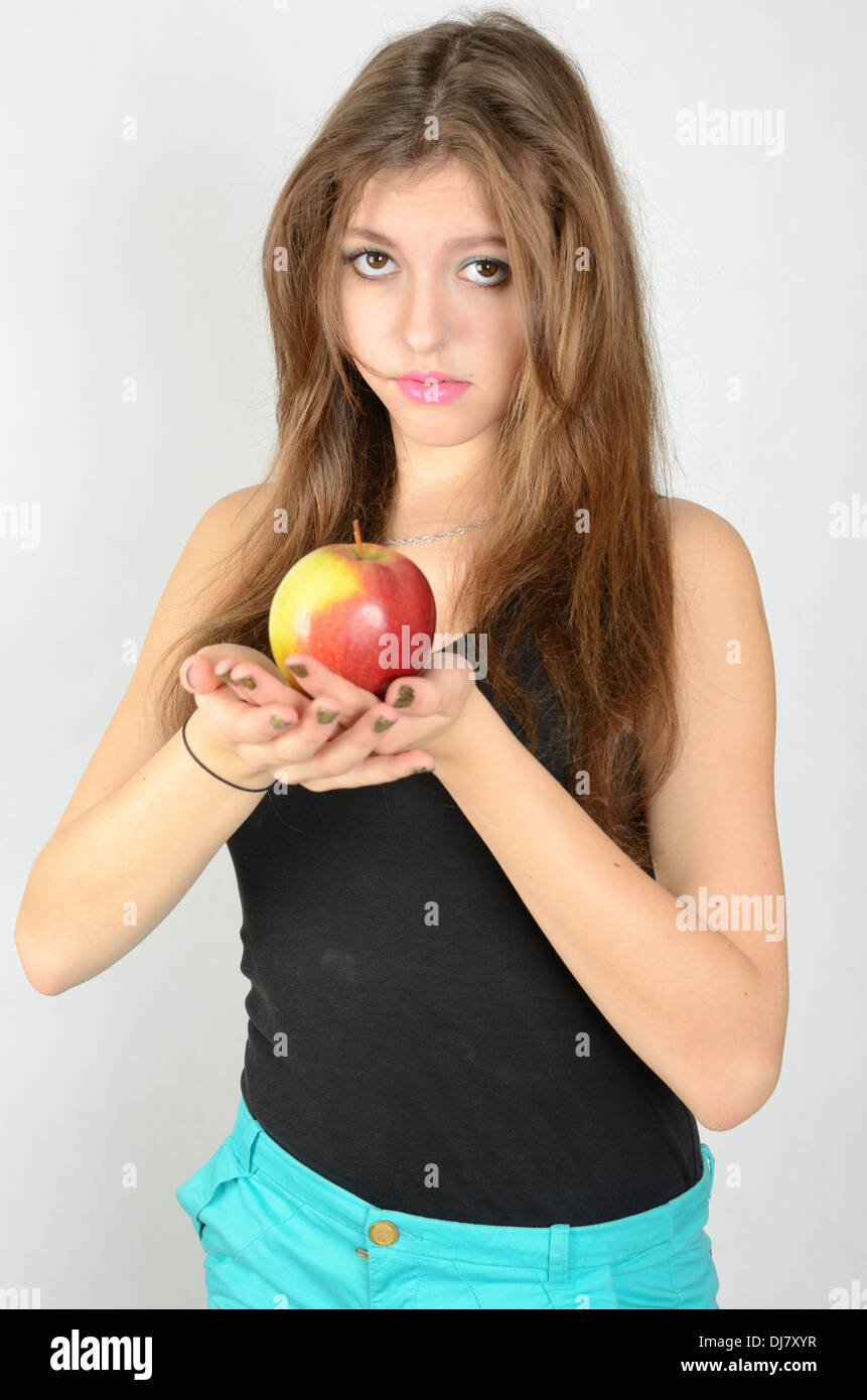 Pretty, young girl holding apple. Female model showing healthy ...