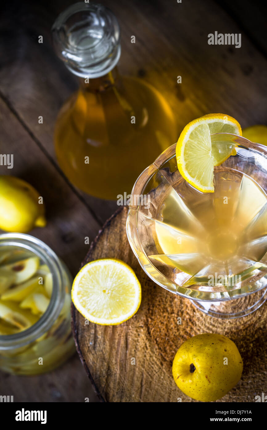 Tincture of quince cups. Fruits in a jar, lemon and carafe Stock Photo ...