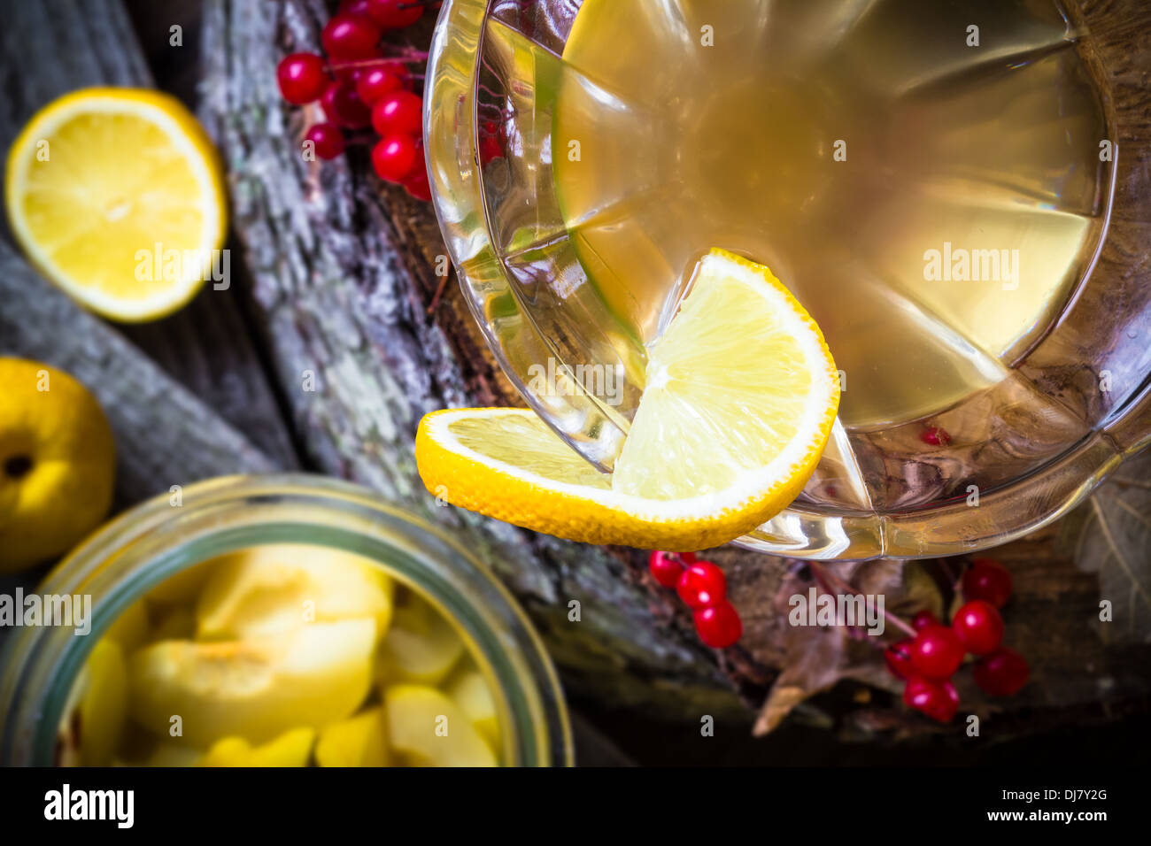 Tincture of quince cups. Fruits in a jar on wooden background Stock ...