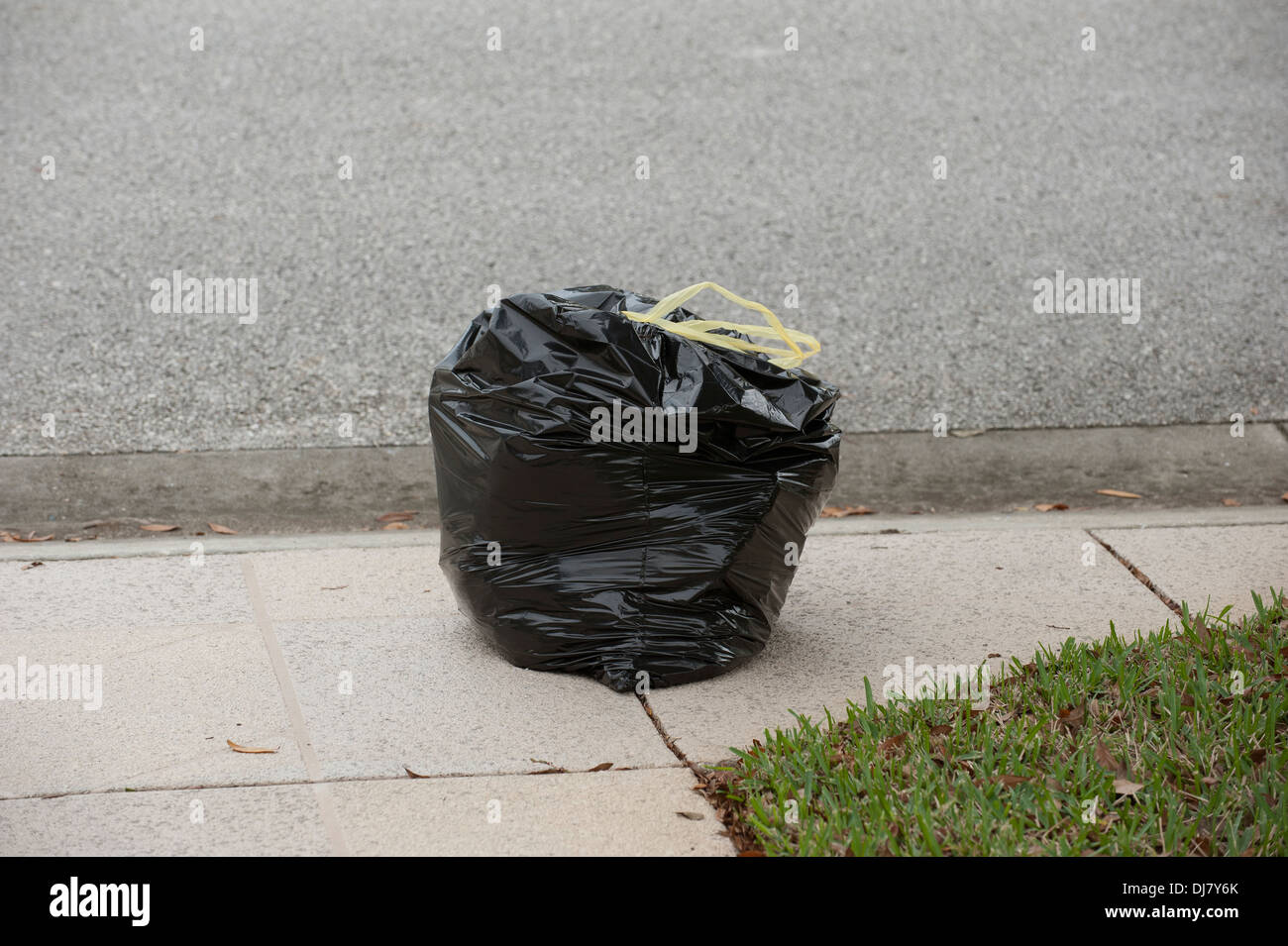 Refuse bag at roadside awaiting collection Stock Photo - Alamy