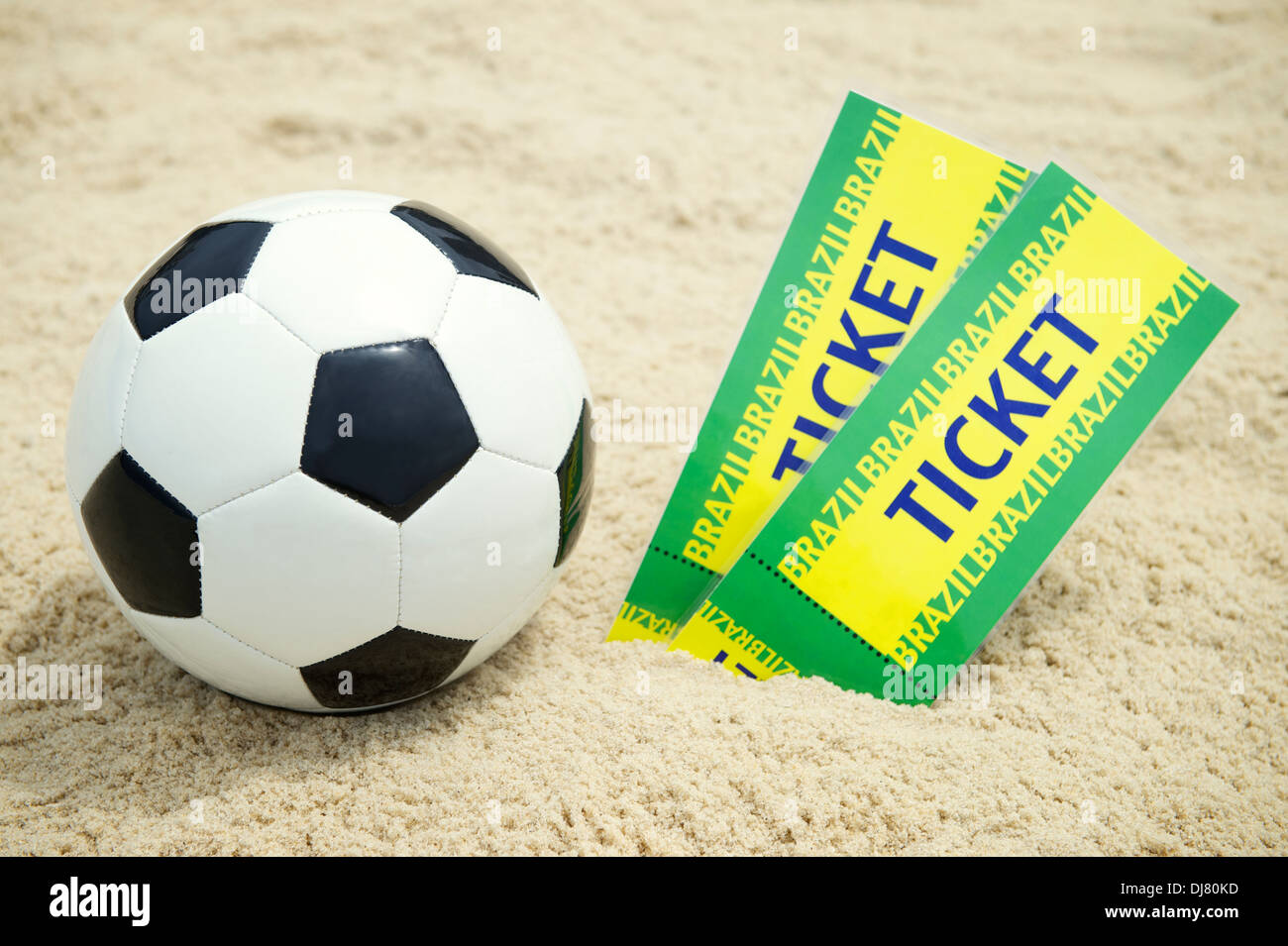 Two tickets to football event stand on Brazilian beach with soccer ball ...