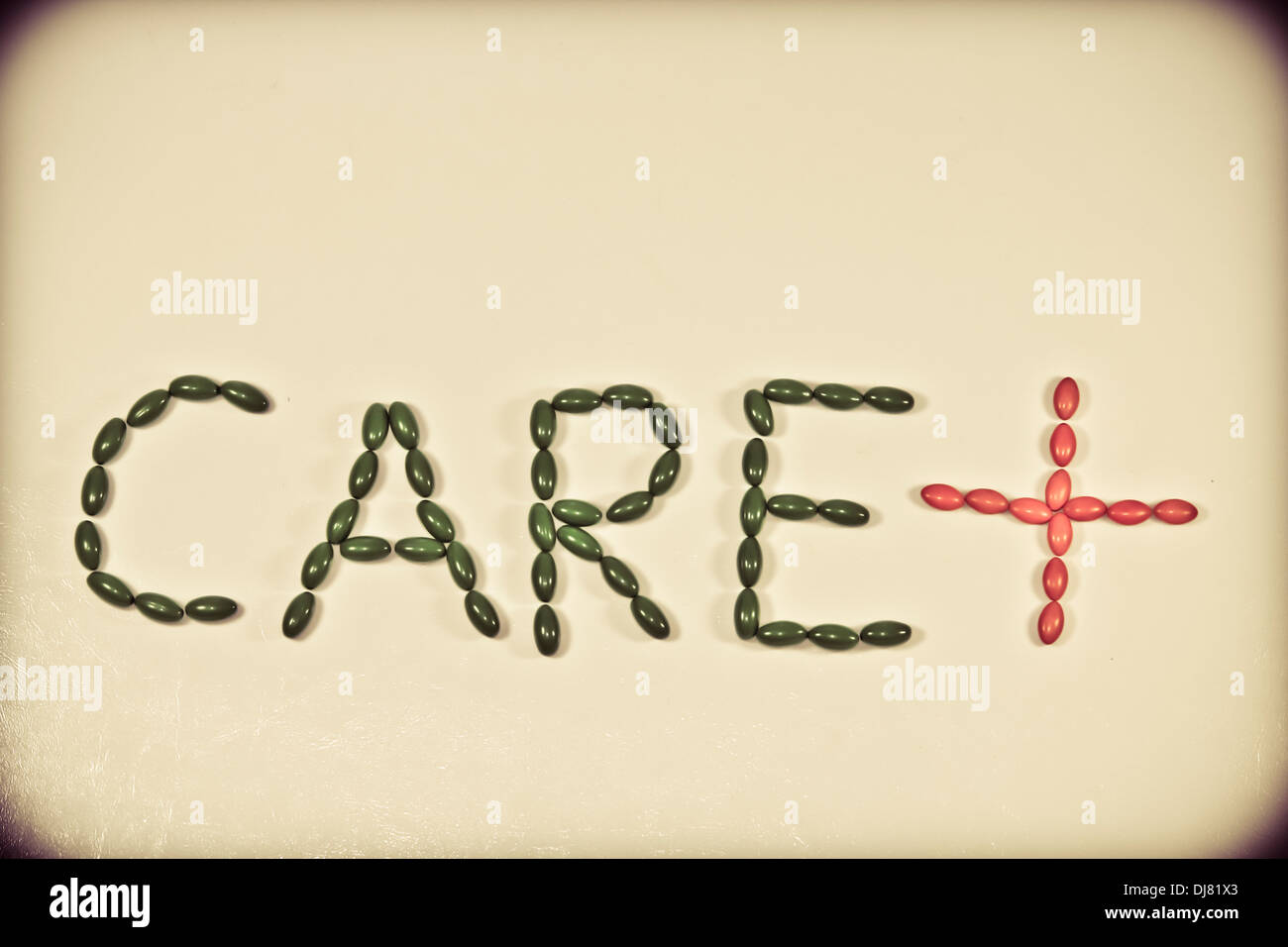 Care Word with cross symbol arranged with pills Stock Photo - Alamy