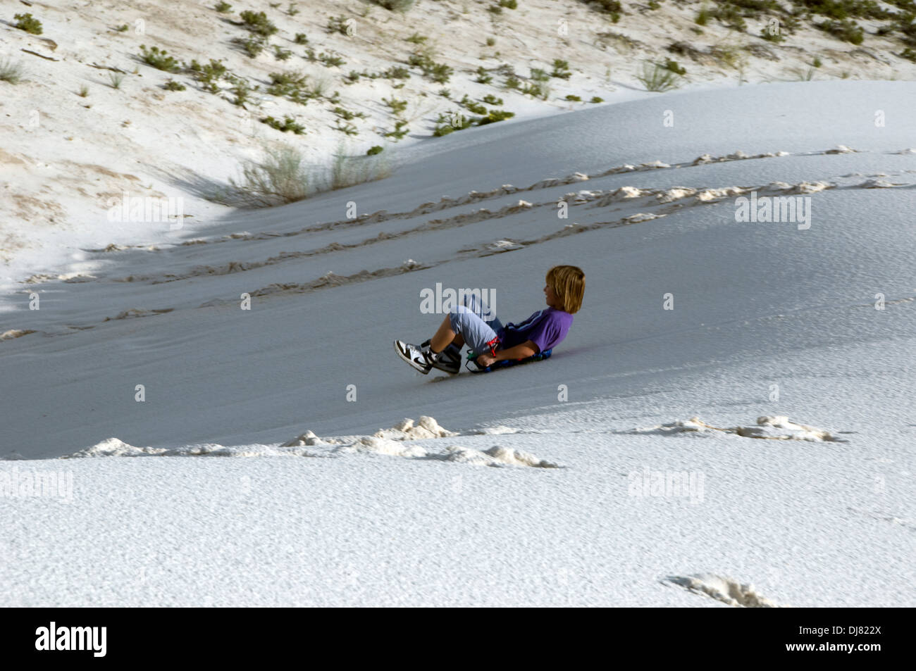 A child sliding on the white sands dune,USA Stock Photo - Alamy