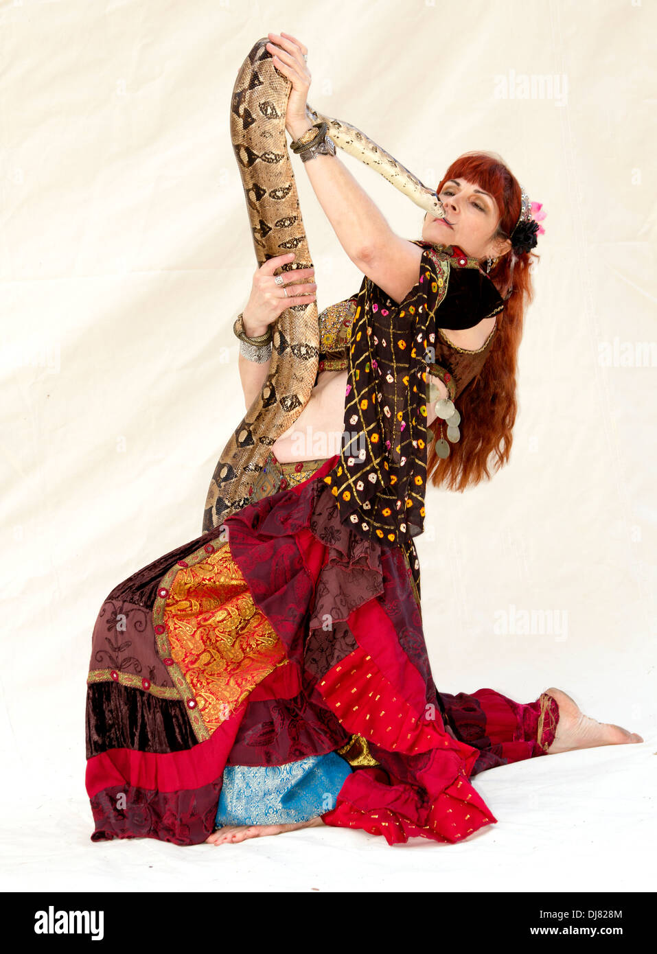 Belly dancer with a snake Stock Photo - Alamy